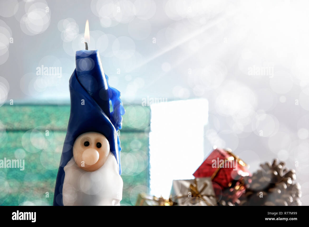 Santa Clause candle and gift boxes Stock Photo - Alamy