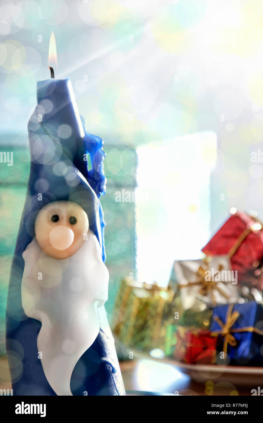 Santa Clause candle and gift boxes Stock Photo - Alamy