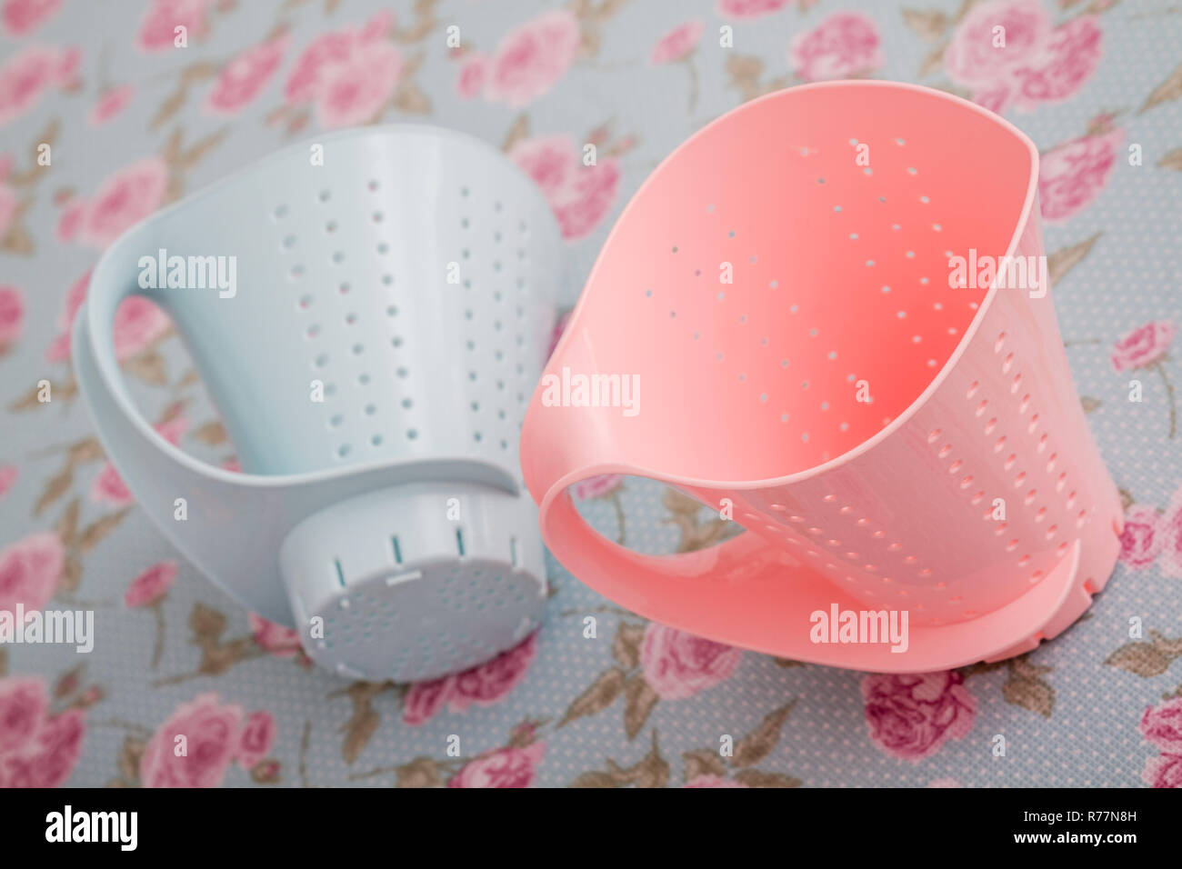 Colorful Plastic Colanders with Handles on Floral Pattern Stock Photo ...