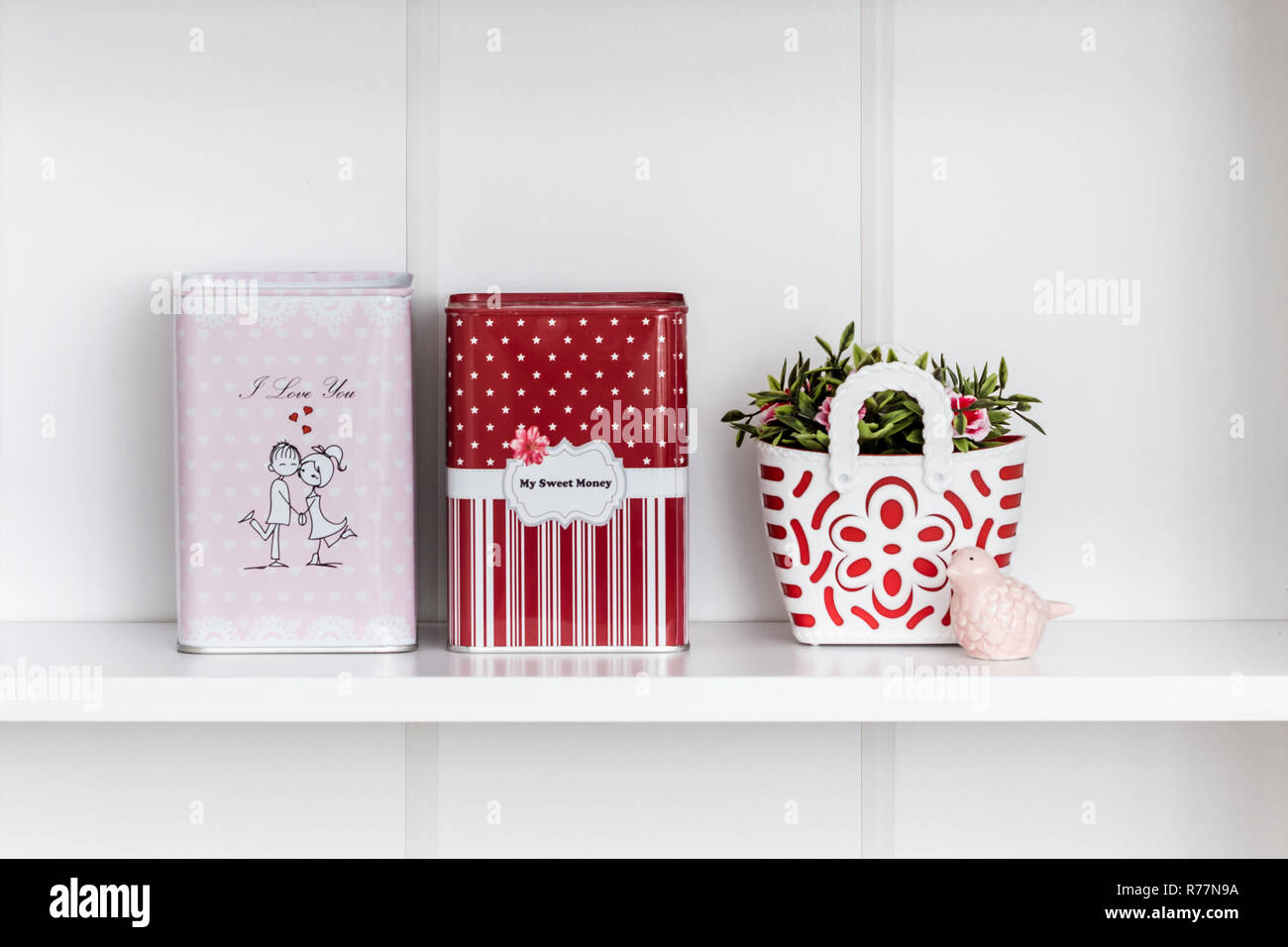 Red Home Related Decorative Objects in a White Shelf Stock Photo - Alamy
