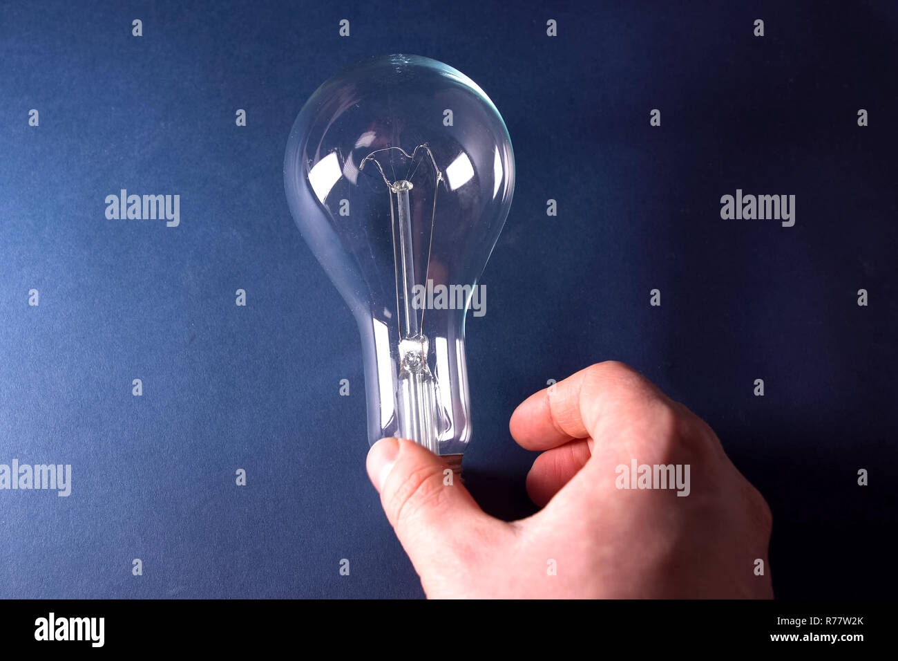 Incandescent lamp in the hand. Lamp is the source of lighting Stock ...