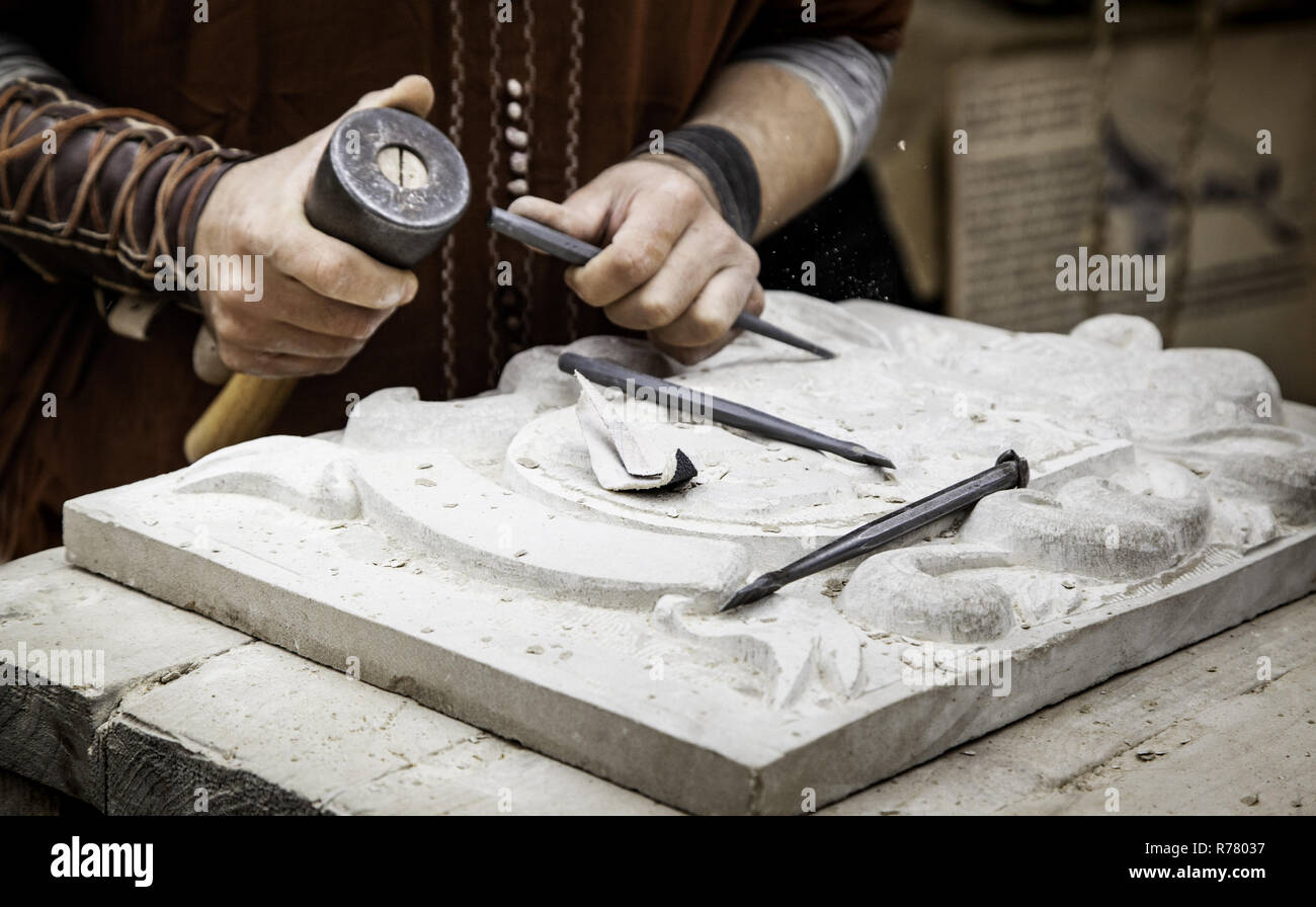 Carving stone in a traditional way, craftsmanship detail, shaping the ...