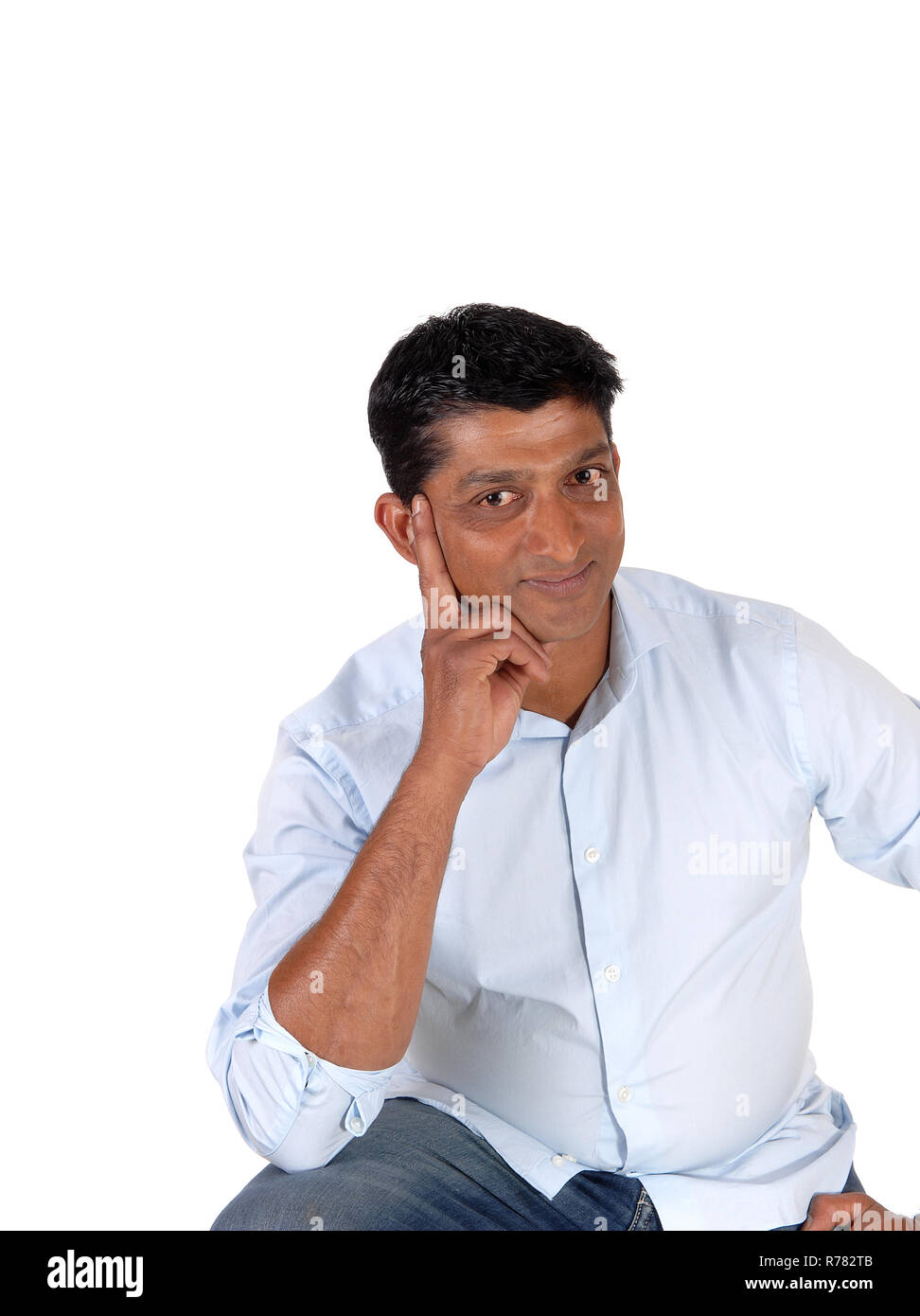 Handsome man thinking with hand on face Stock Photo - Alamy