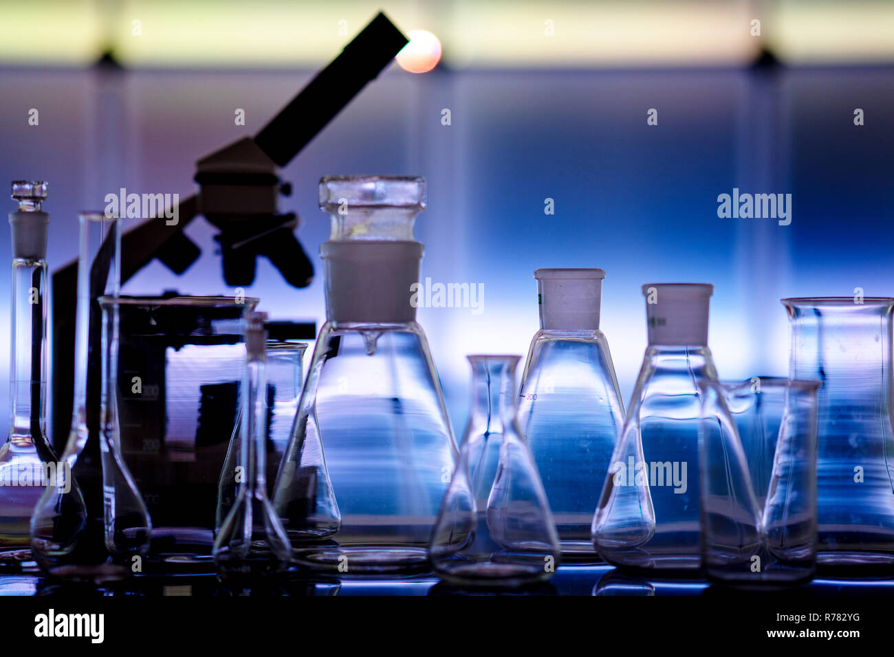 Empty chemical glassware on color background. Group of laboratory empty ...
