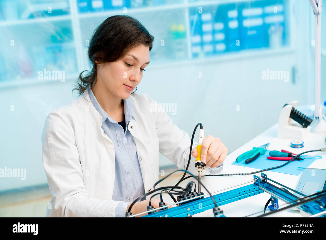 Student girl in electronics laboratory, experiment with microcontroller ...