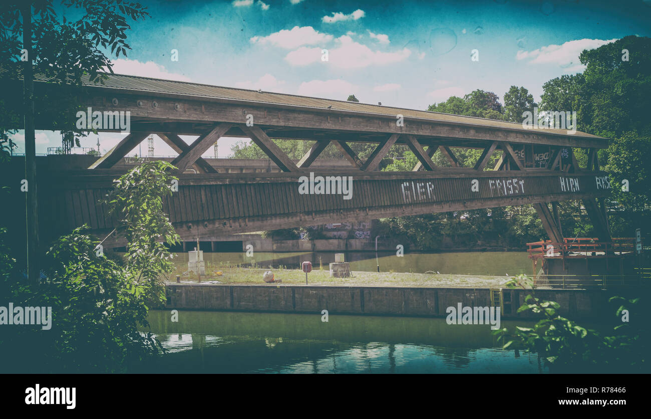 A remaining half of an old wooden bridge Stock Photo - Alamy
