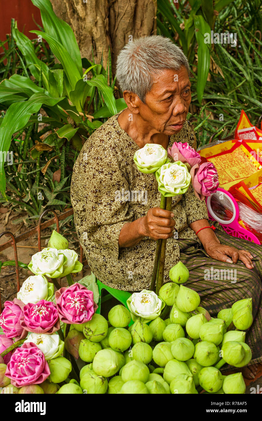 old woman selling lotus flowers and votive paper for Chinese New Year ...