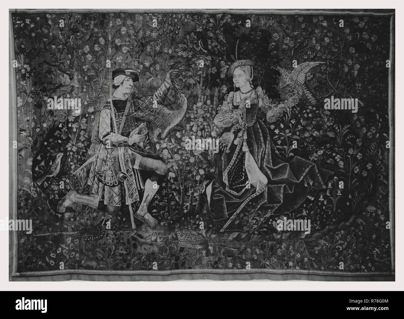 Huntsman presenting captured heron to lady falconer Stock Photo - Alamy