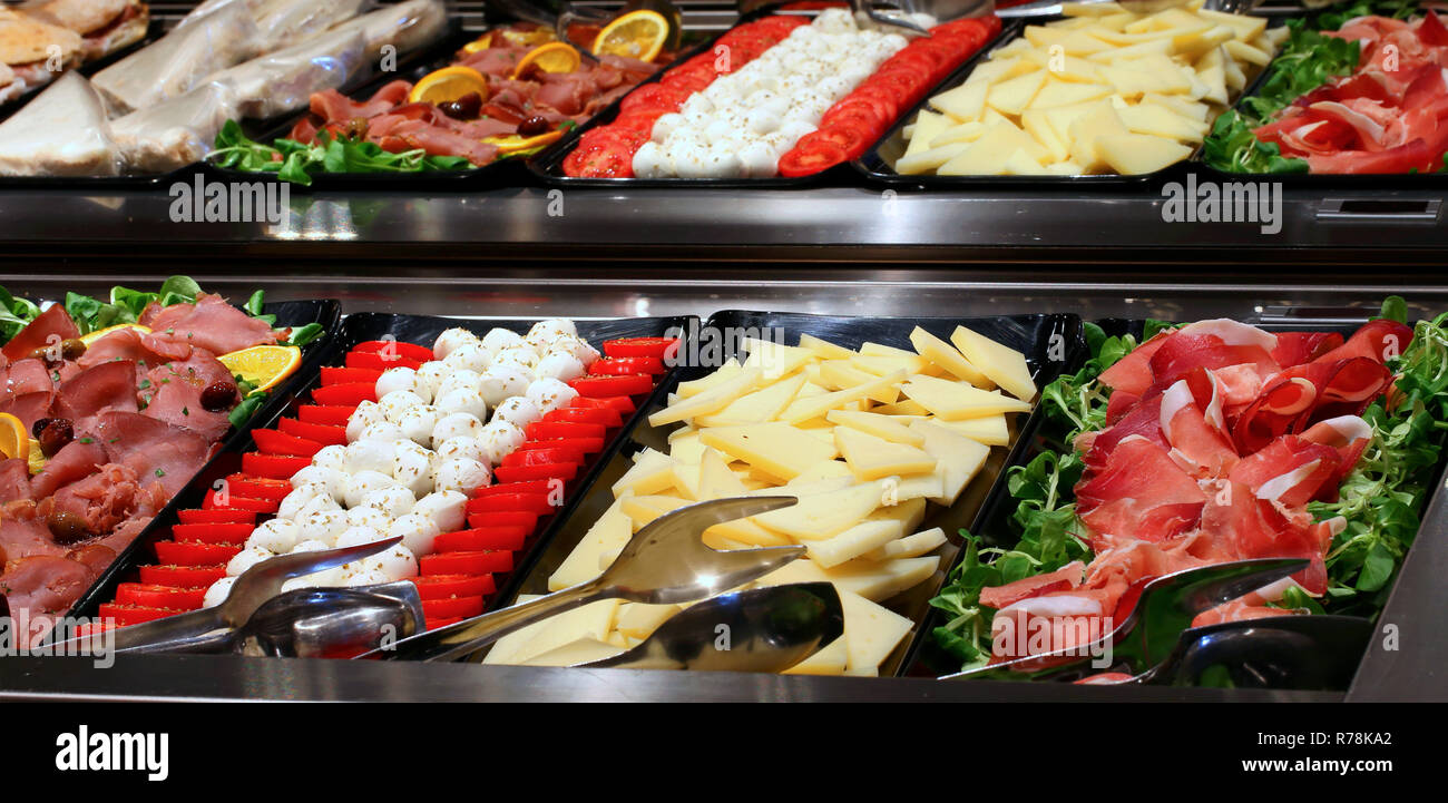tray filled with food and tomato mozzarella cheeses and vegetables ...