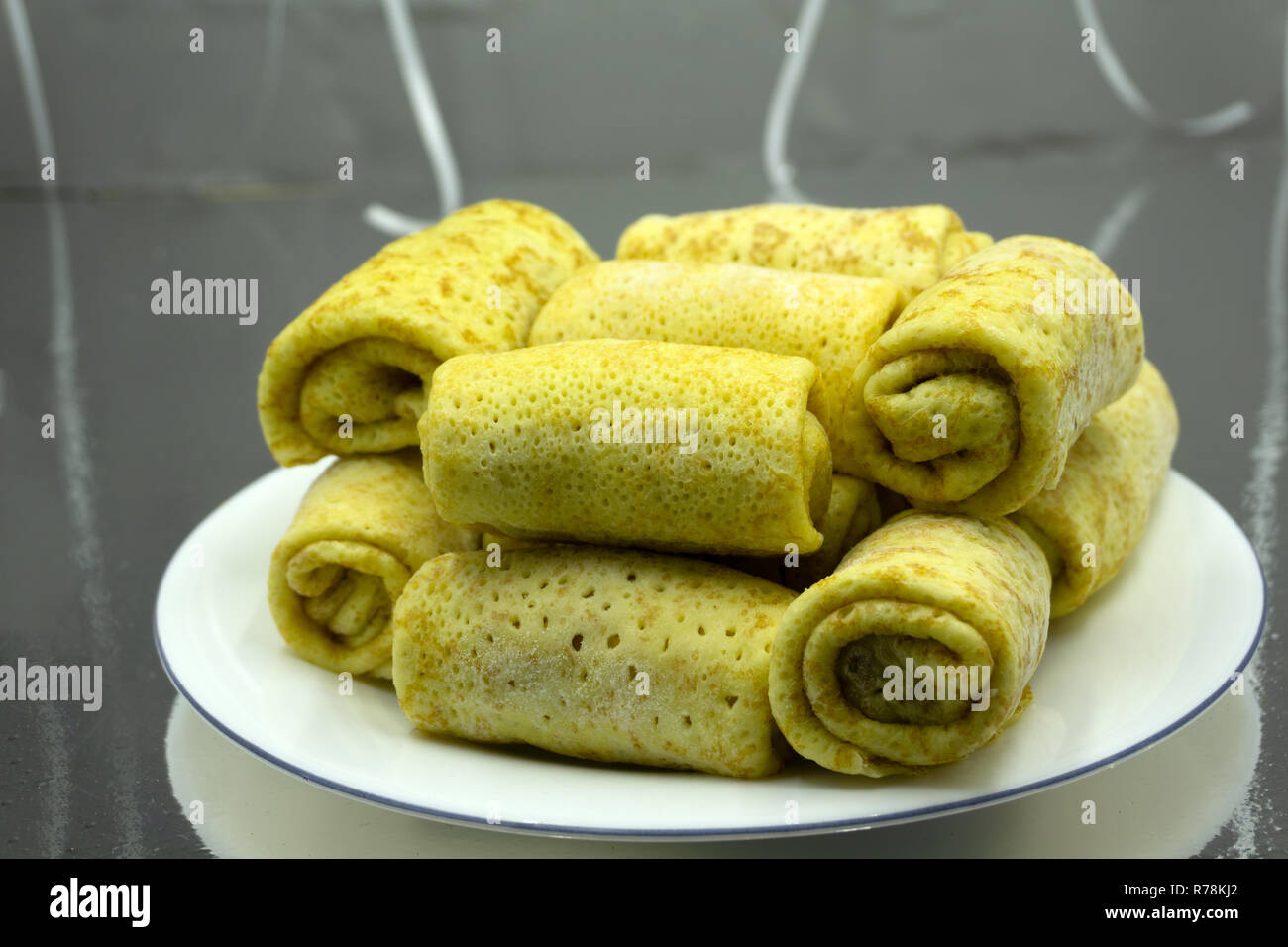 Fried spring rolls on black slate plate on grey stone slate background ...