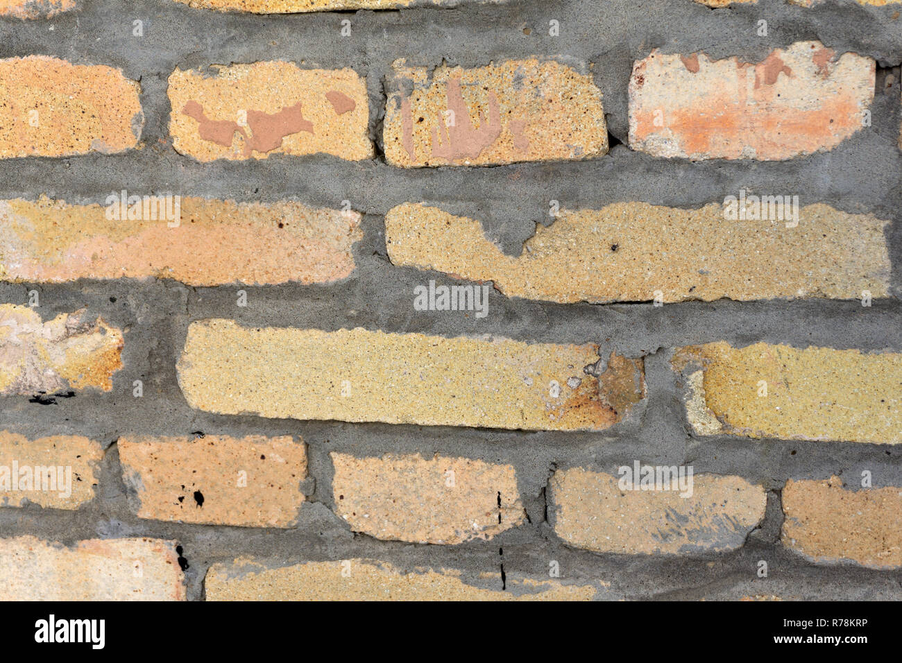 Part of the wall of refractory bricks peach color with concrete seams ...