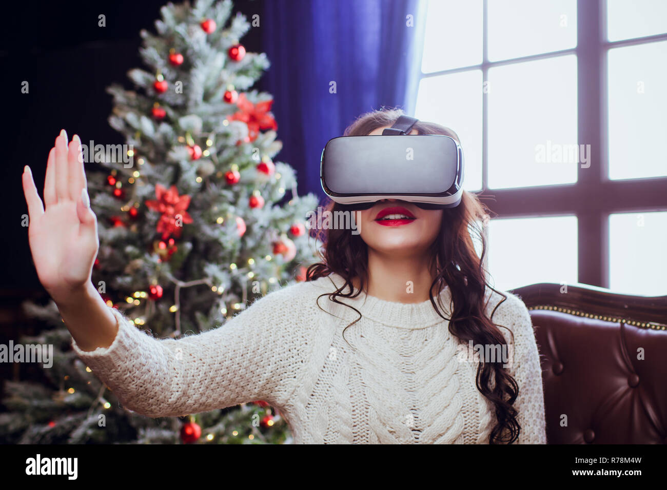 Attractive woman wearing virtual reality goggles. VR headset. Virtual ...