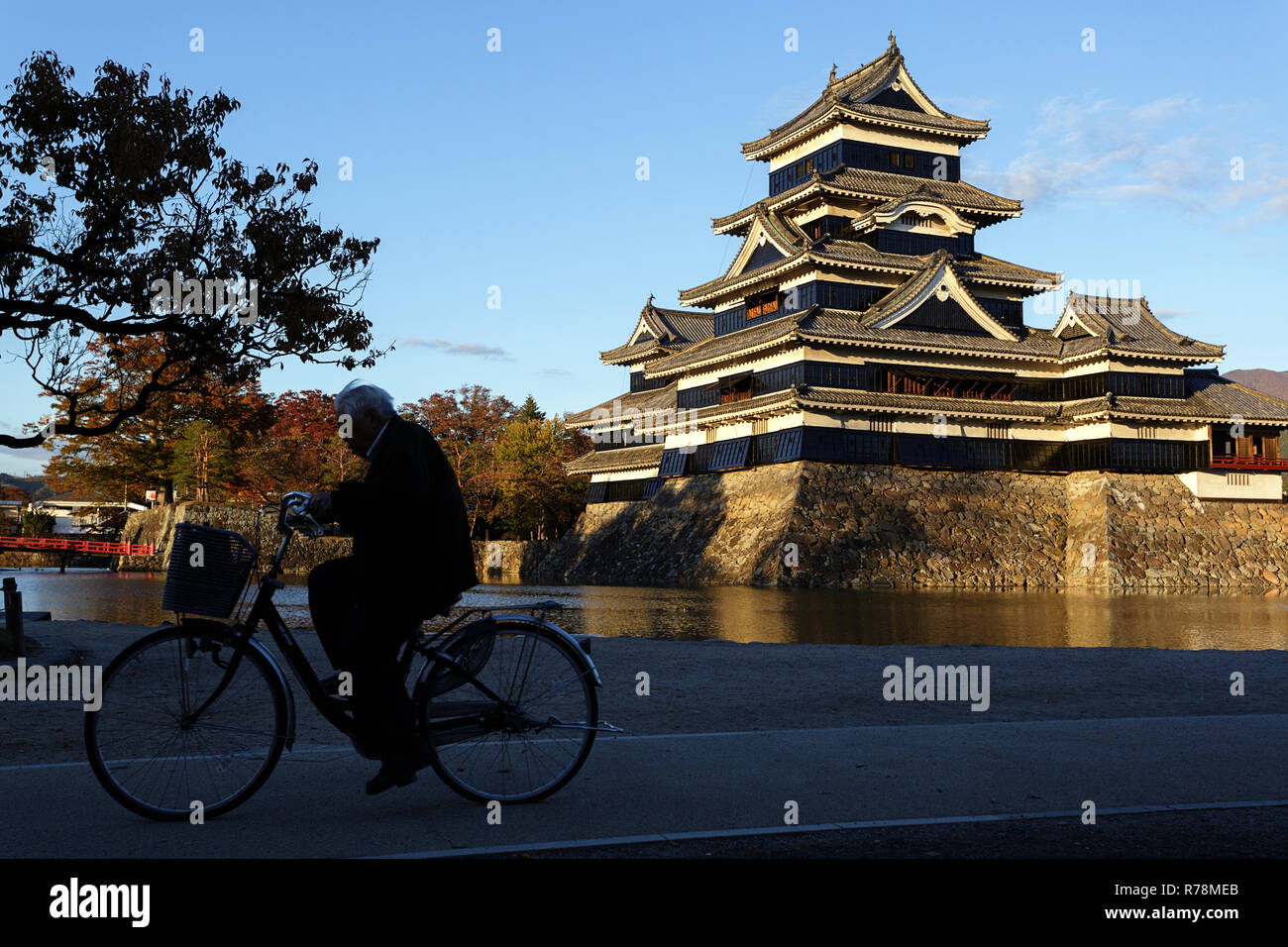 Cyclist at Matsumoto, Japan. Matsumoto Castle (Crow Castle, Fukashi ...