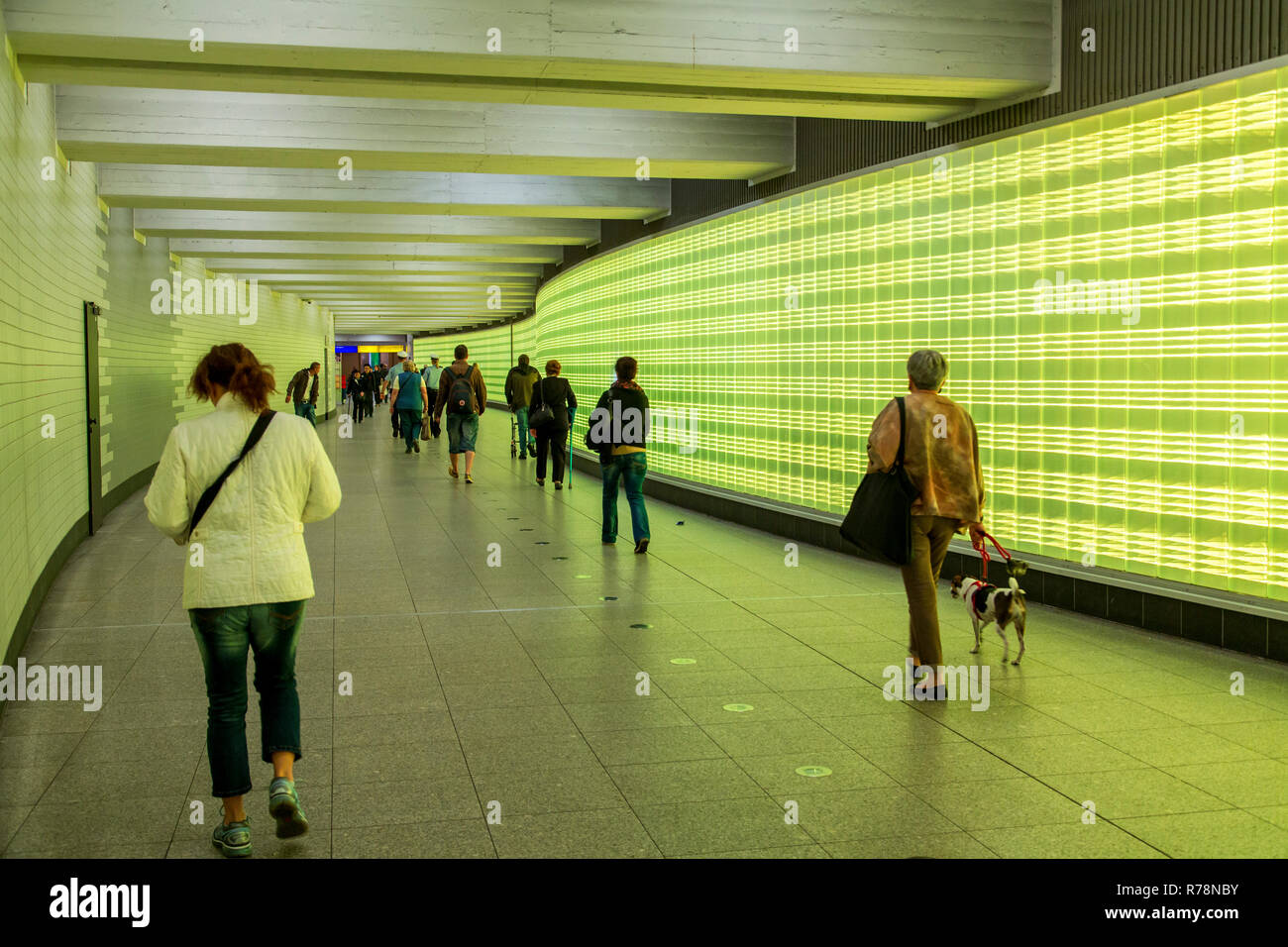 Passers-by, underground passage in the main station, with illuminated ...
