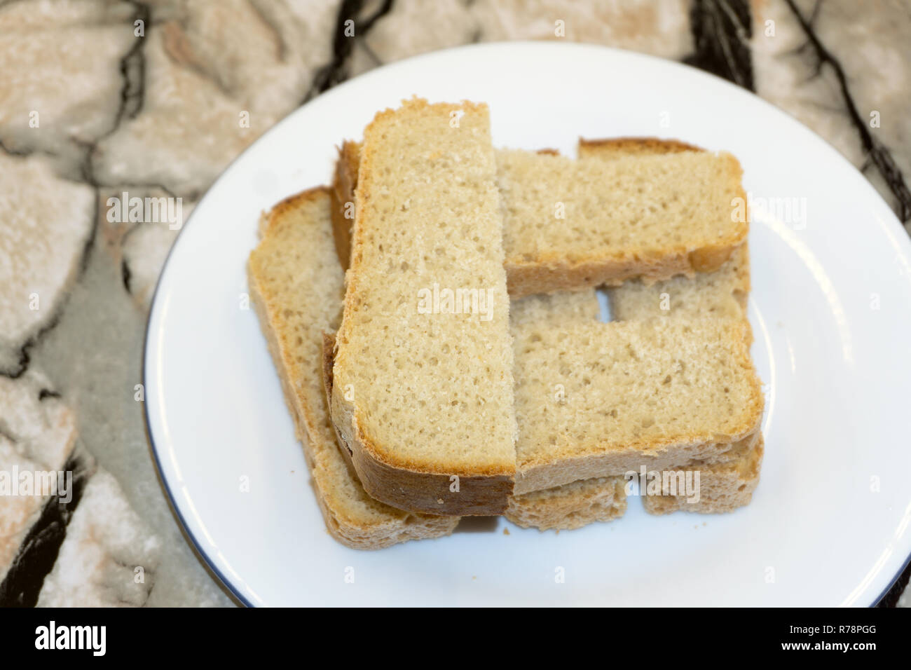 Wooden cutting board with sliced white bread and knife on wooden table ...