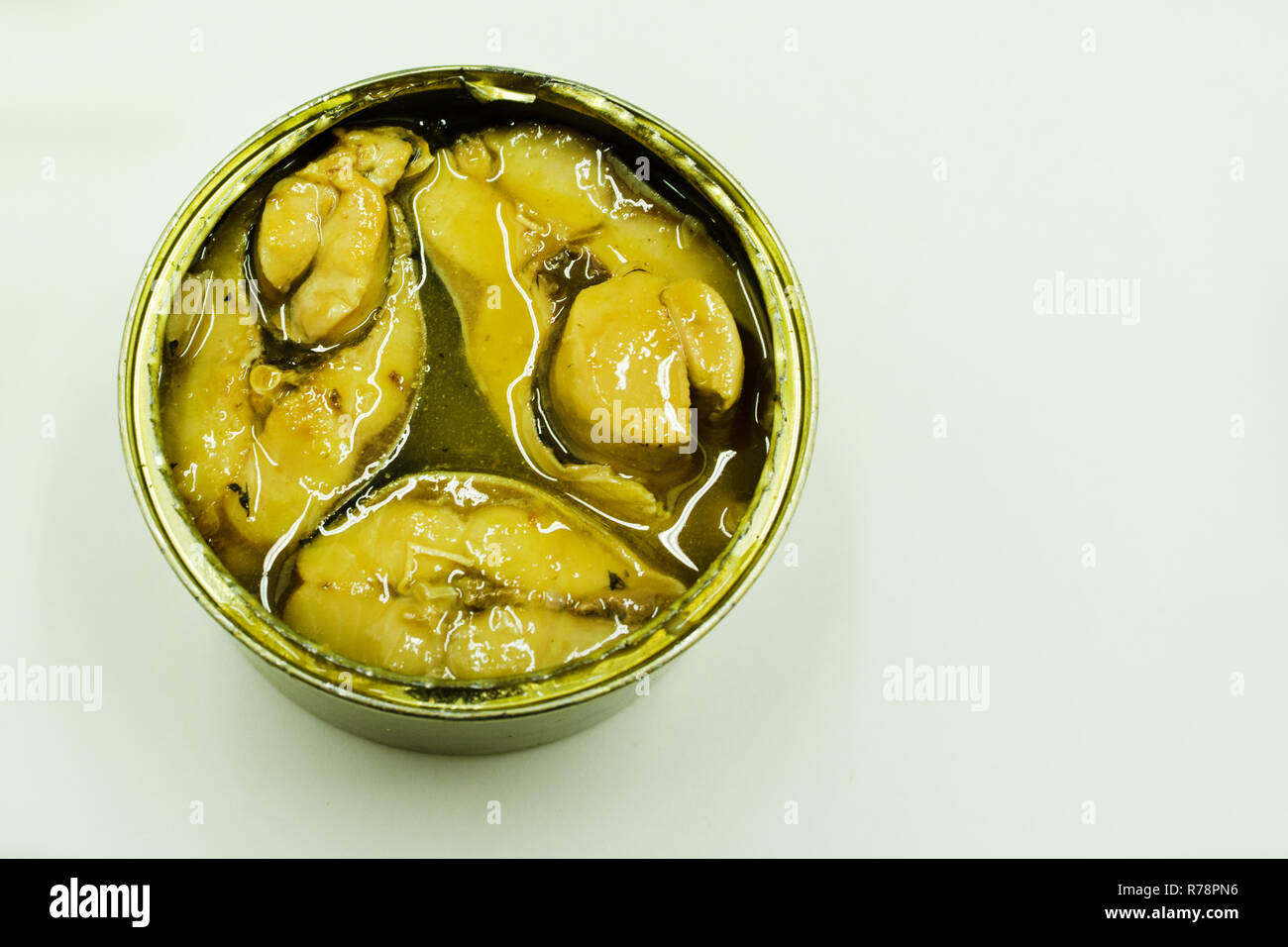 Canned fish on a rustic blue table Stock Photo - Alamy