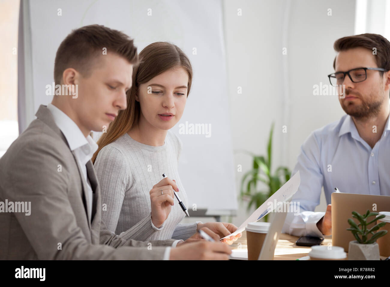 Serious employees talk collaborating at business meeting Stock Photo ...