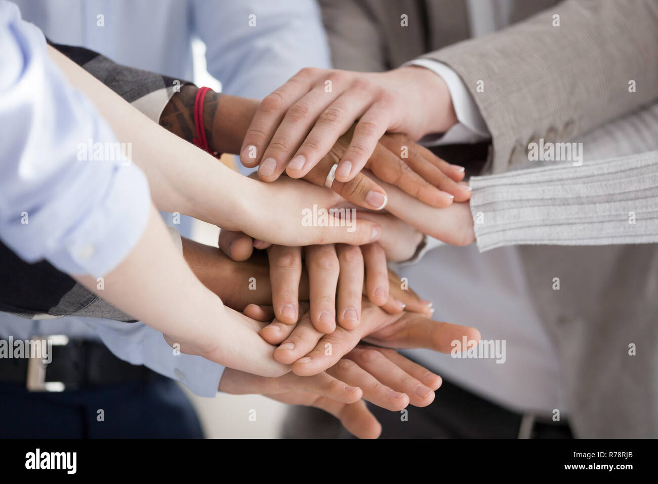 Close up of diverse people put hands in stack Stock Photo - Alamy