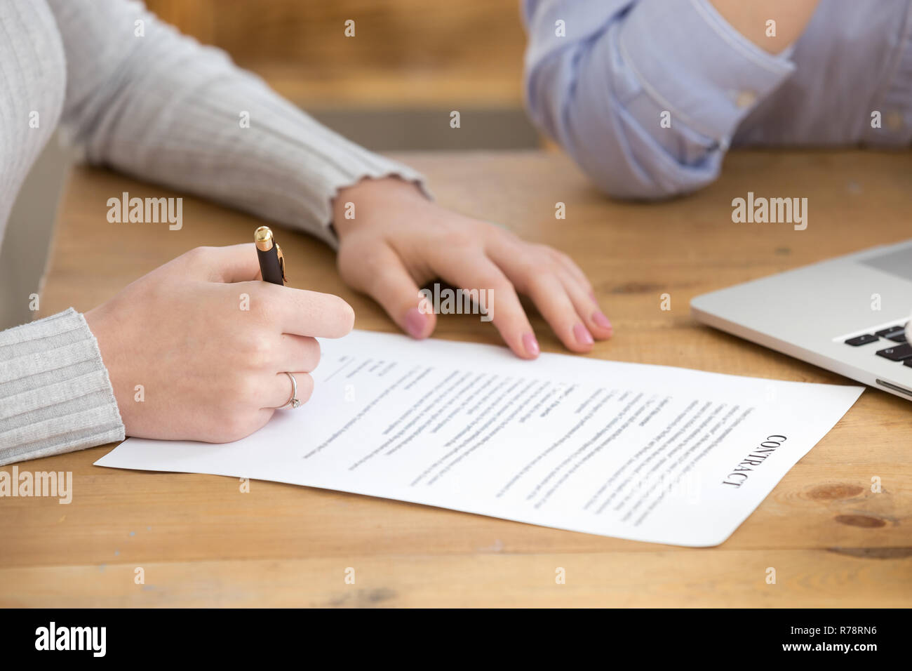 Woman signing bank hi-res stock photography and images - Alamy