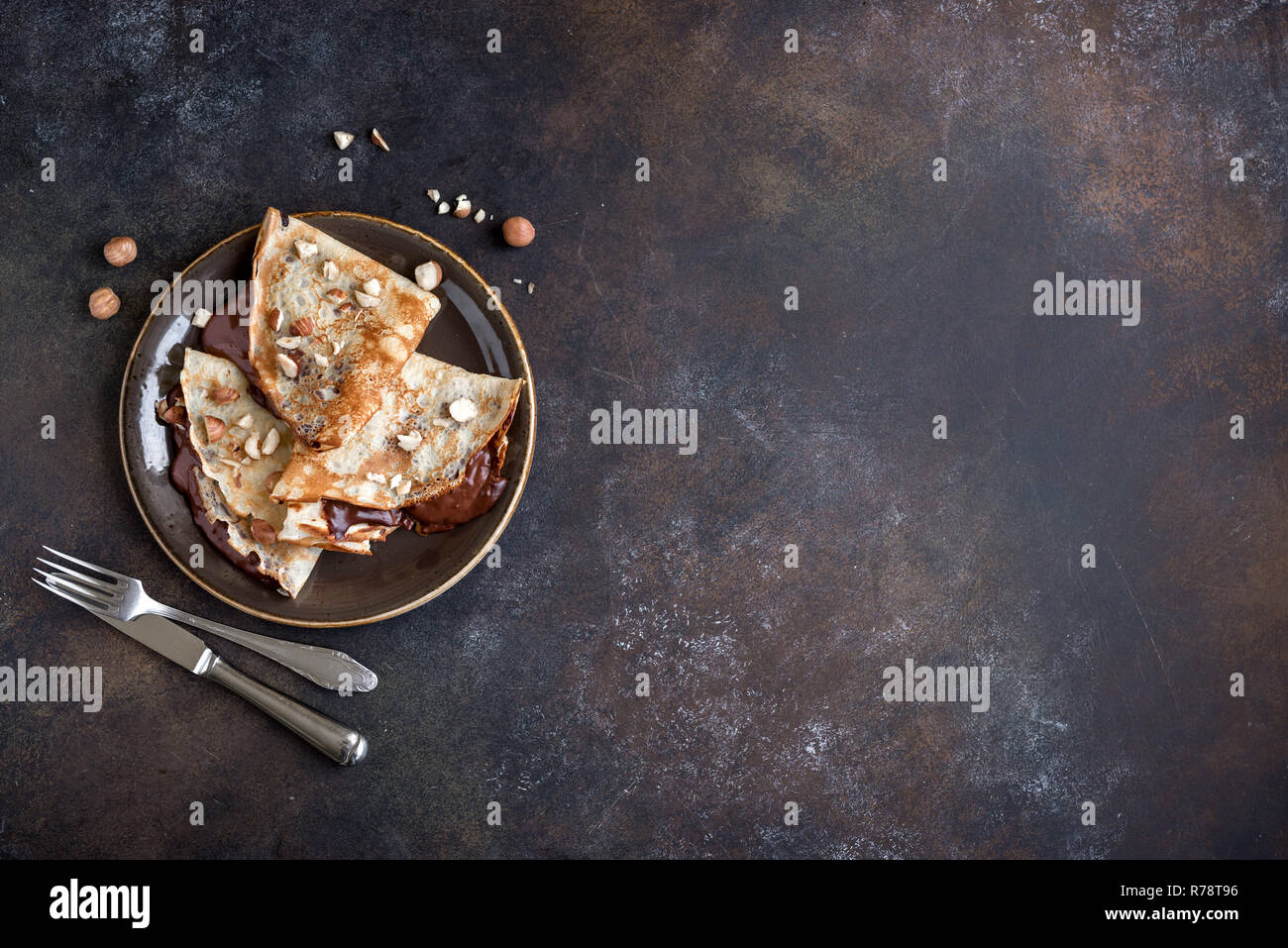 Crepes with chocolate spread and hazelnuts. Homemade thin crepes for ...