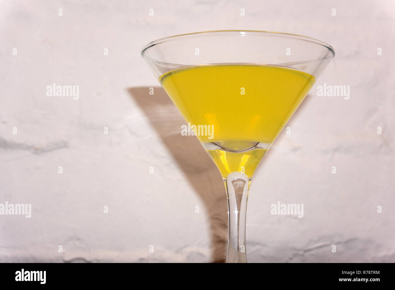 Yellow cocktail in martini glass isolated on a white background Stock ...