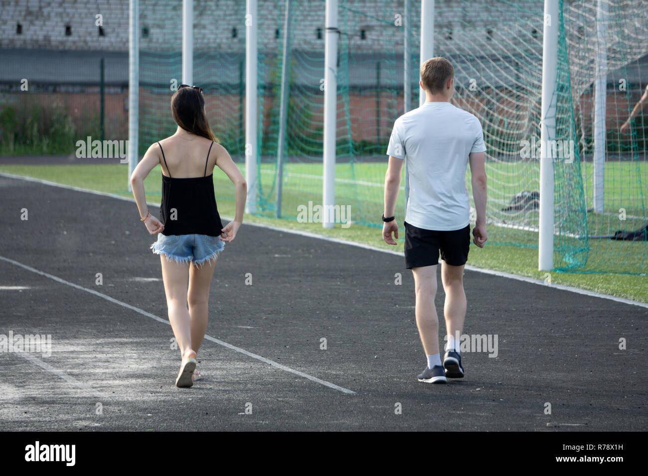 Two young men running on race track. Male professional athletes running ...