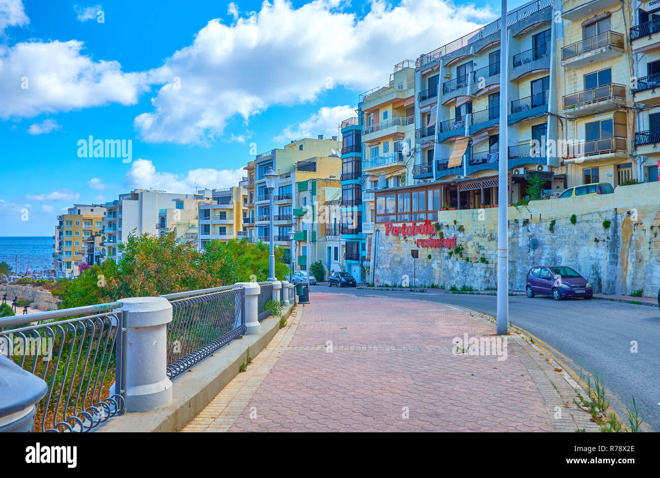 BUGIBBA, MALTA - JUNE 14, 2018: The seaside view residential buildings ...