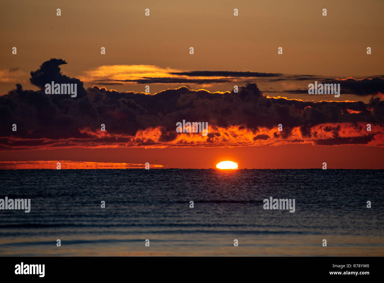 colorful sunset or sunrise in the sea with bright colors and dramatic ...