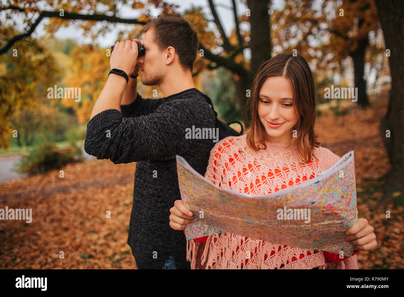Beutiful couple travelling together. She holds map and study it. He ...