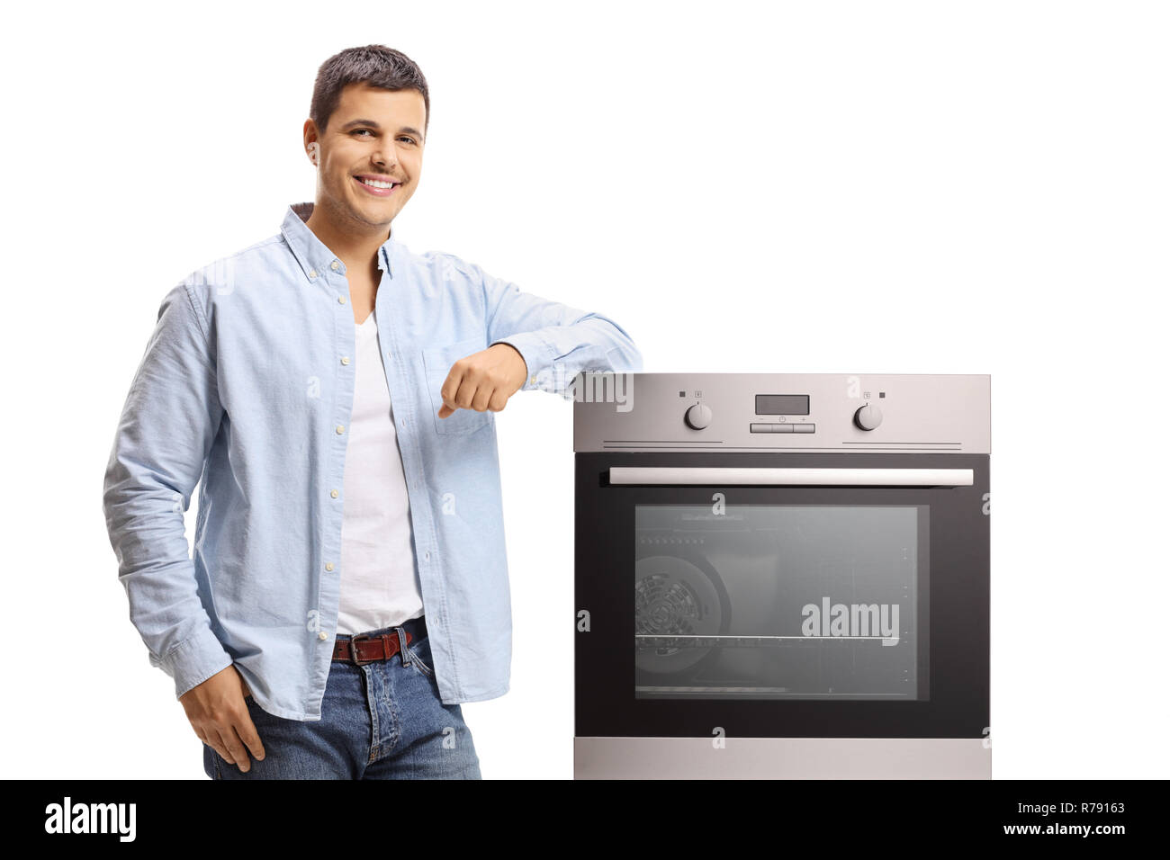 Young guy with an oven isolated on white background Stock Photo - Alamy