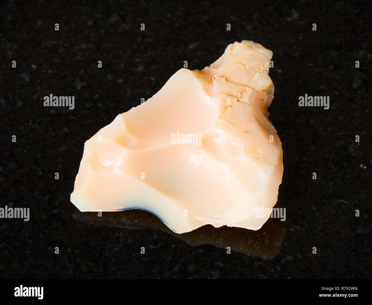 rough noble opal gemstone on black Stock Photo - Alamy