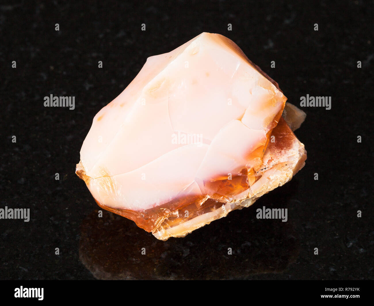 raw precious opal and fire opal gem on black Stock Photo - Alamy