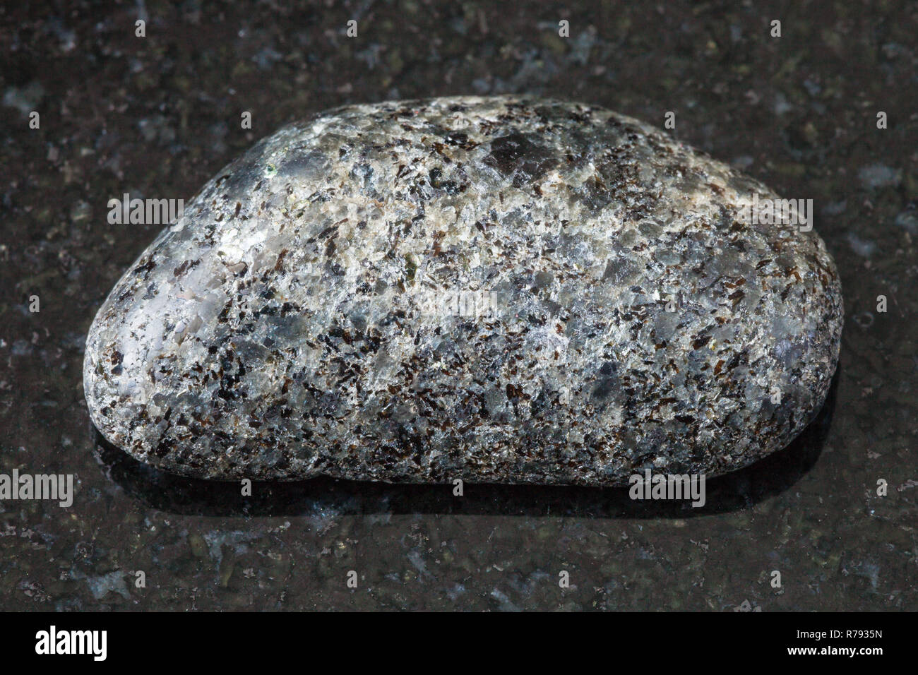 tumbled Peridotite stone with Phlogopite on black Stock Photo - Alamy