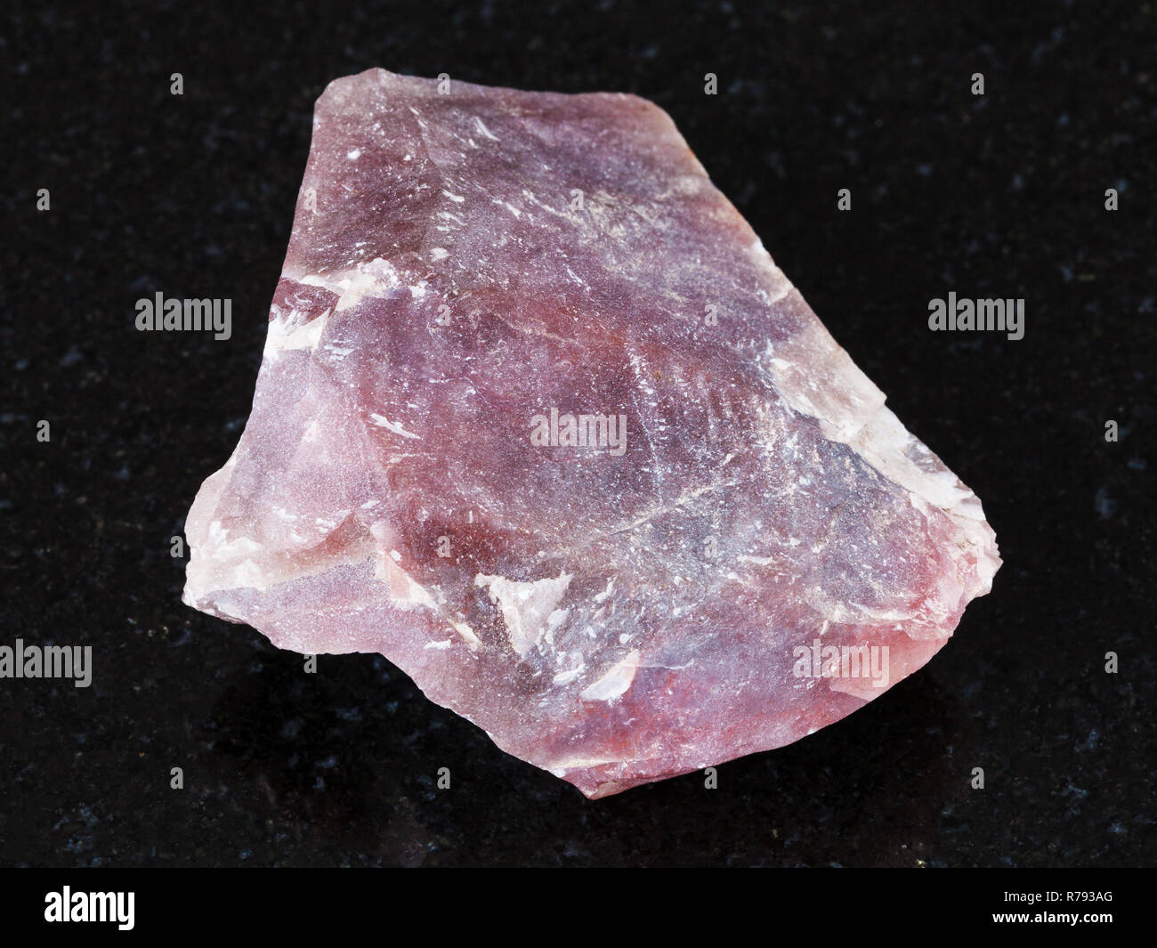 rough pink Flint stone (Chalcedony) on black Stock Photo - Alamy