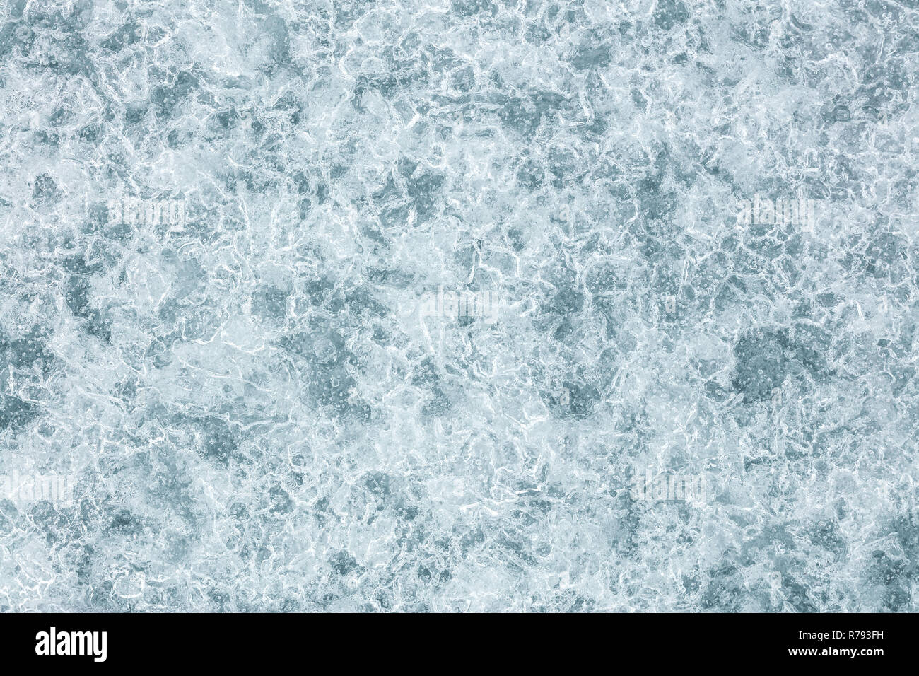 Cracked patterns of frozen river water surface, macro view Stock Photo ...