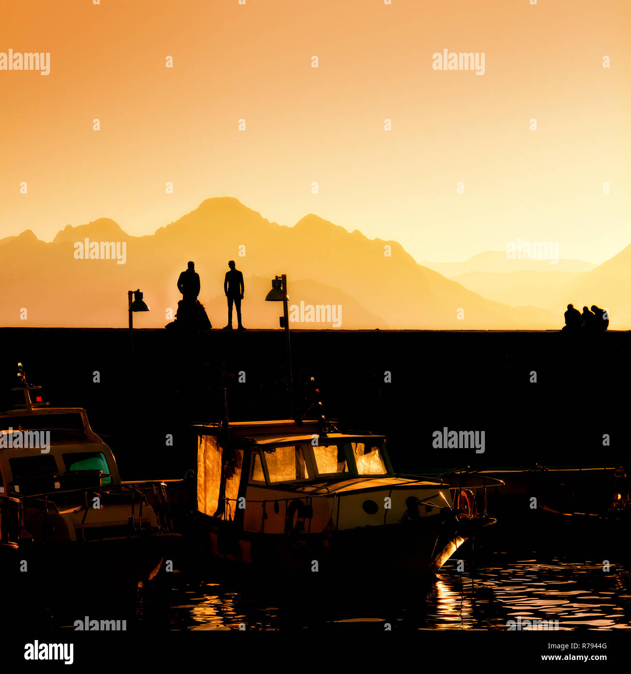 people at harbor during sunset Stock Photo - Alamy