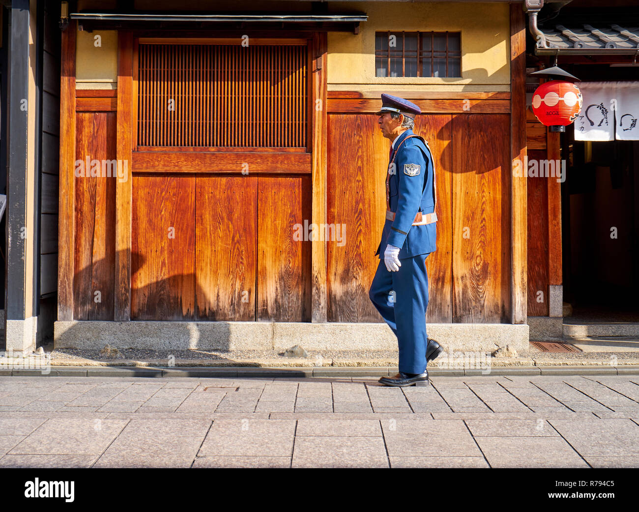 Local security guard walking down the streets of Gion. Strait posture ...