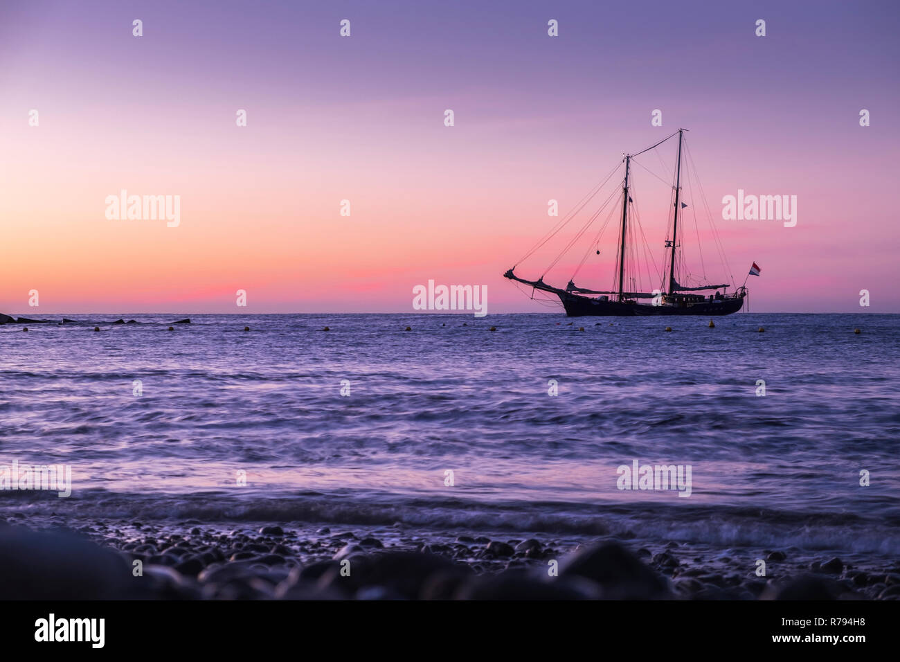 Two masted sailing ship, ketch, flying a French flag, moored offshore ...