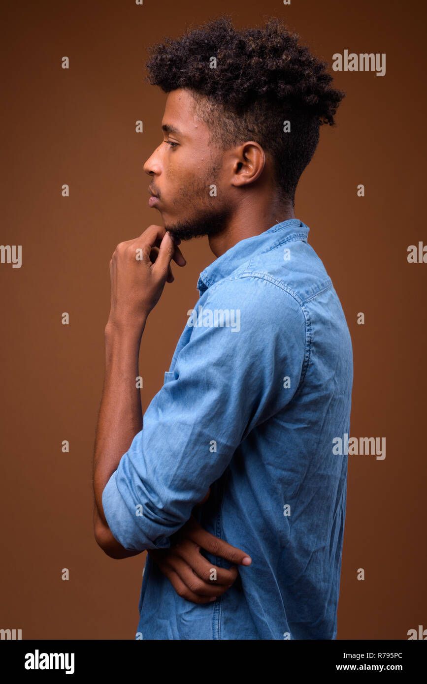 Profile view portrait of young handsome African man thinking Stock ...