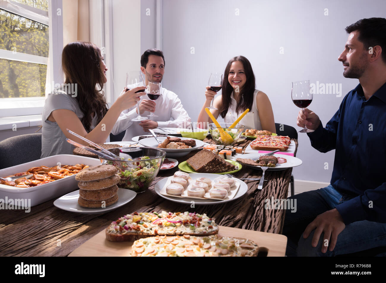 Family friends enjoying laughter food hi-res stock photography and ...