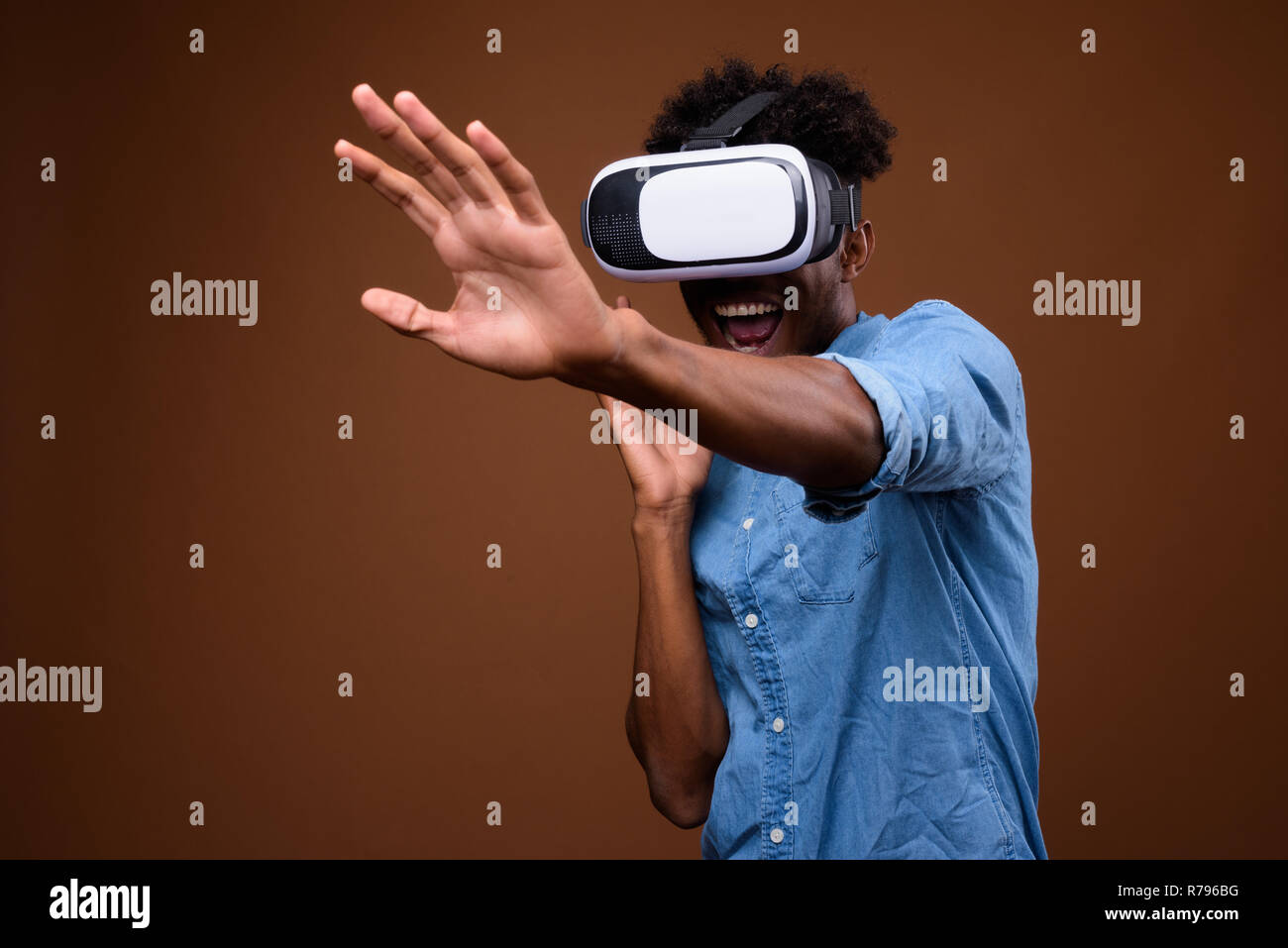 African man enjoying virtual reality while using VR glasses Stock Photo ...