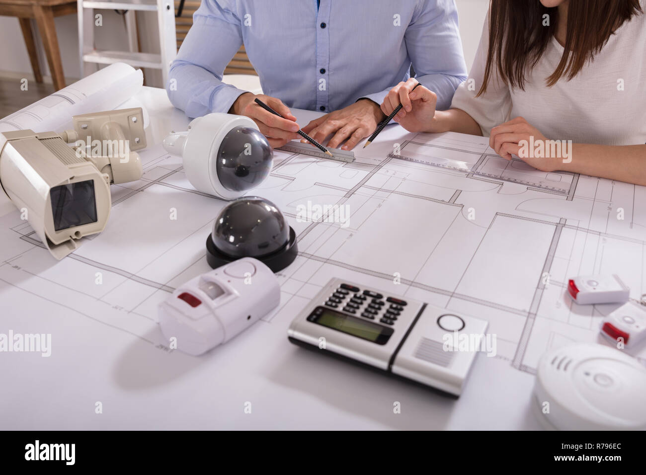 Two Architects Planning Project On Blueprint Stock Photo - Alamy