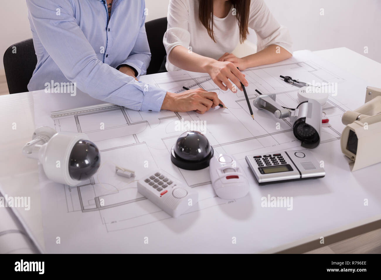 Two Architects Planning Project On Blueprint Stock Photo - Alamy