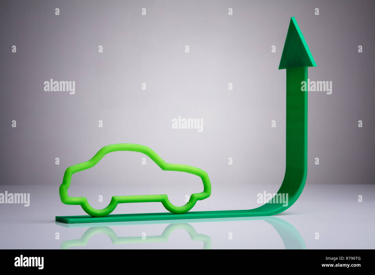 Blue Car Driving On Green Upward Arrow Stock Photo - Alamy