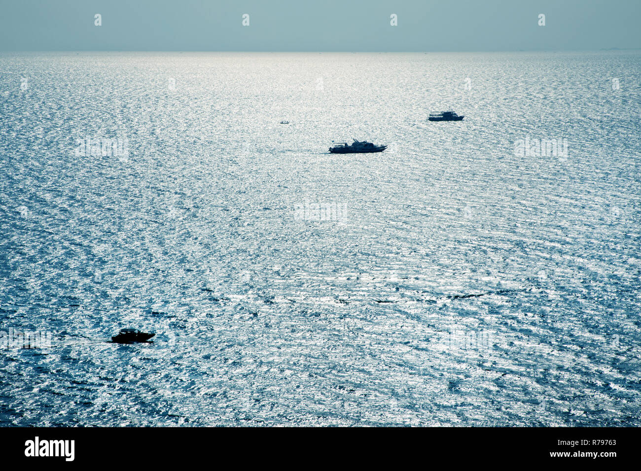 Boats on shiny sea Stock Photo - Alamy