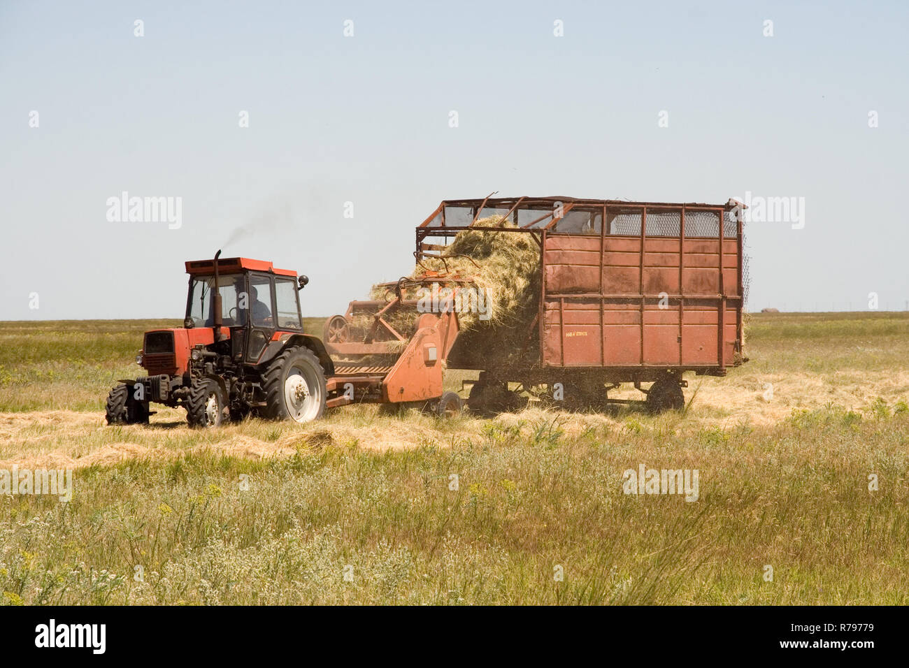 Tractor with hay Stock Photo - Alamy