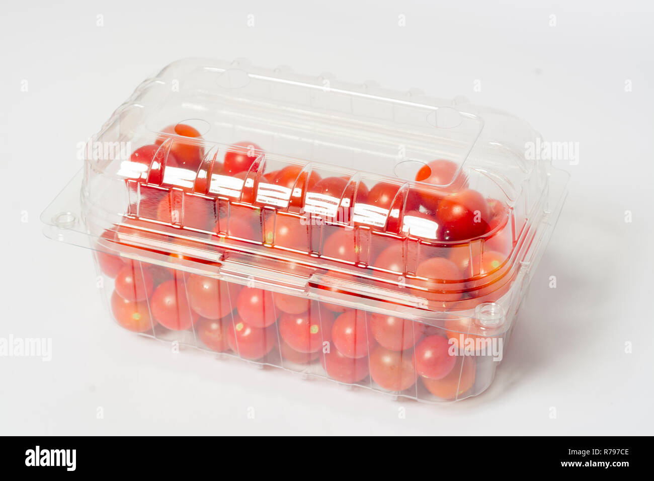 Cherry tomato in plastic container package, studio shoot on white Stock ...