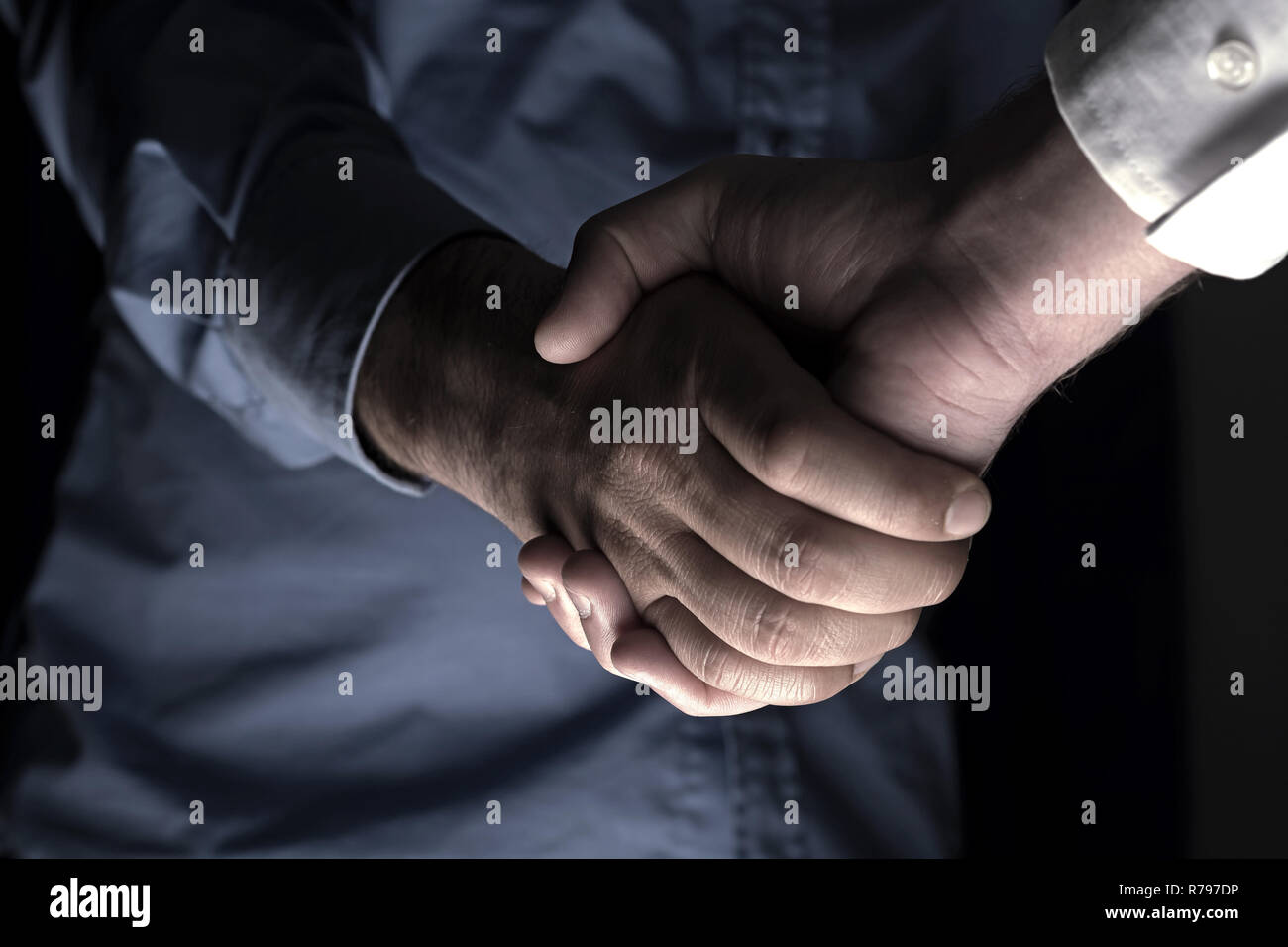 Handshaking of two business man. Low light Stock Photo - Alamy