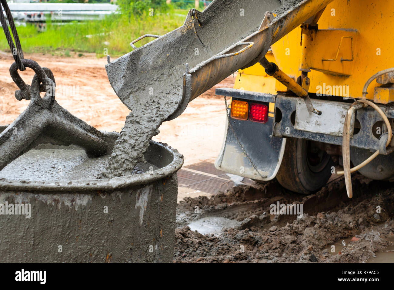 Pouring cement down from the cement mixer truck in construction site ...