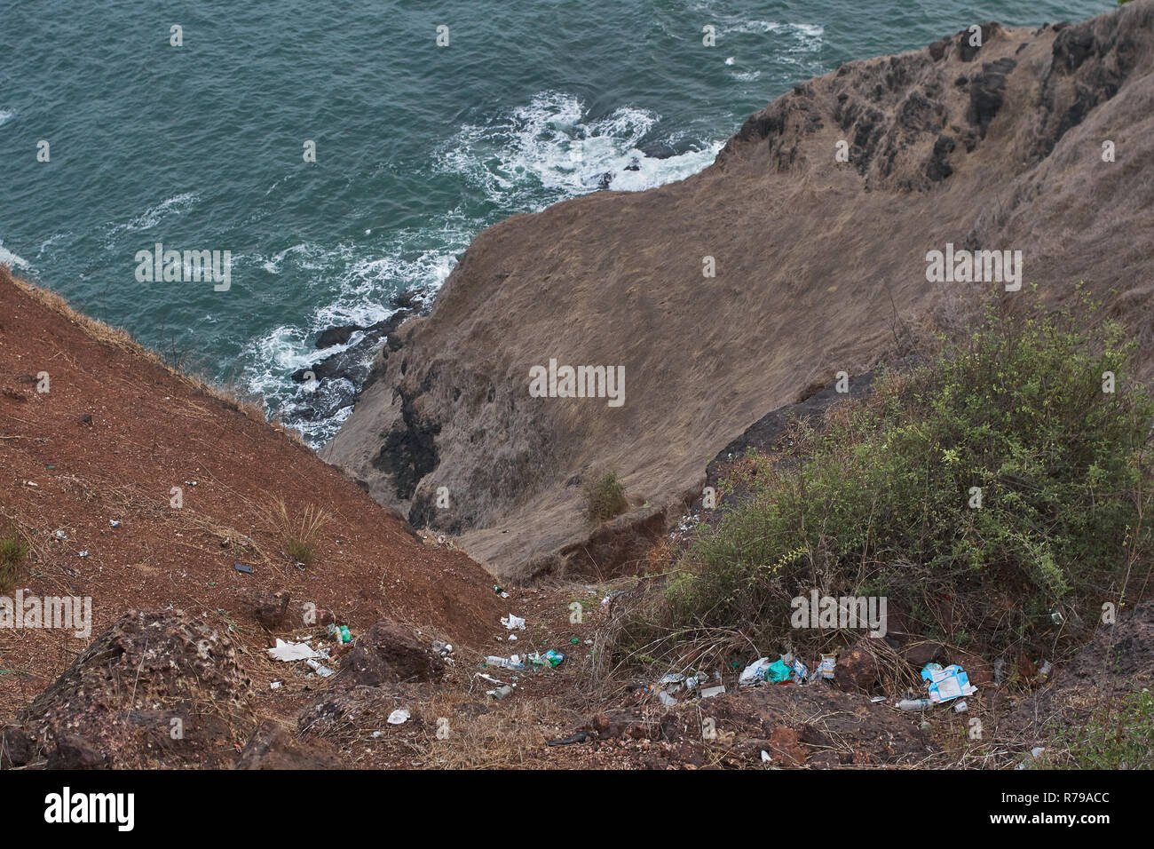 Garbage laying in a cliff going down to the sea Stock Photo - Alamy